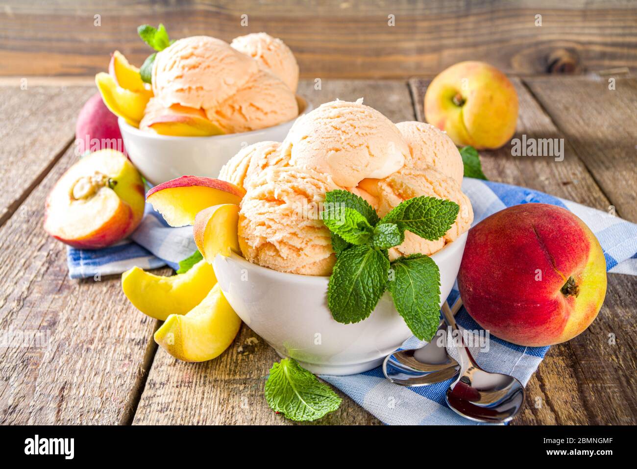 Homemade sweet peach ice cream. Peach gelato balls in small bowls, on ...