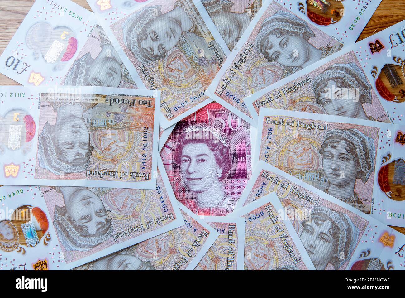 Fifty Pound note surrounded by Ten Pound Notes revelling the queens ...