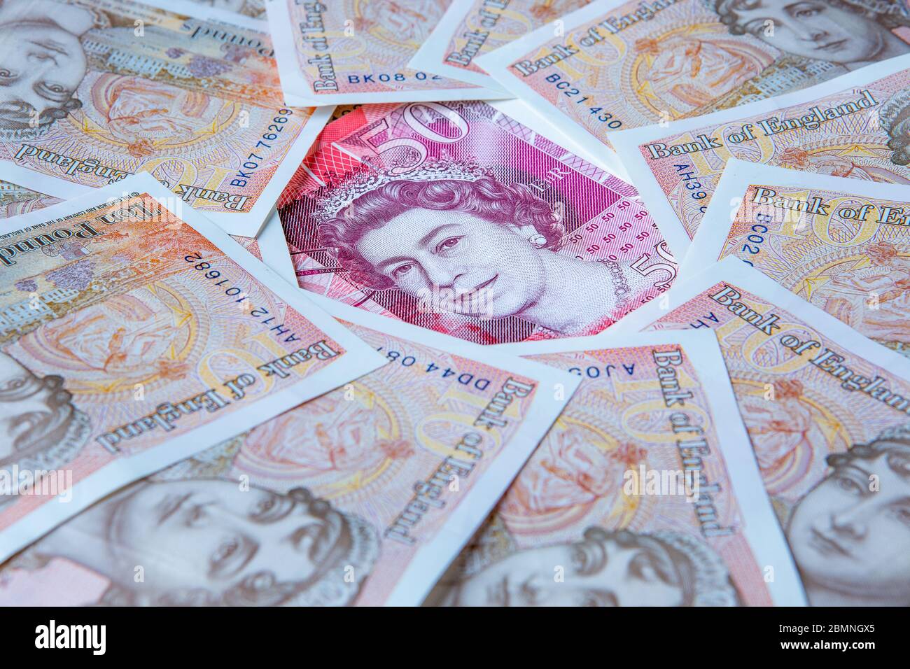 Fifty Pound note surrounded by Ten Pound Notes revelling the queens ...