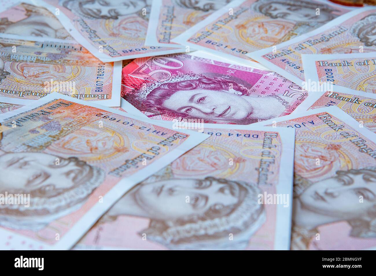 Fifty Pound note surrounded by Ten Pound Notes revelling the queens ...