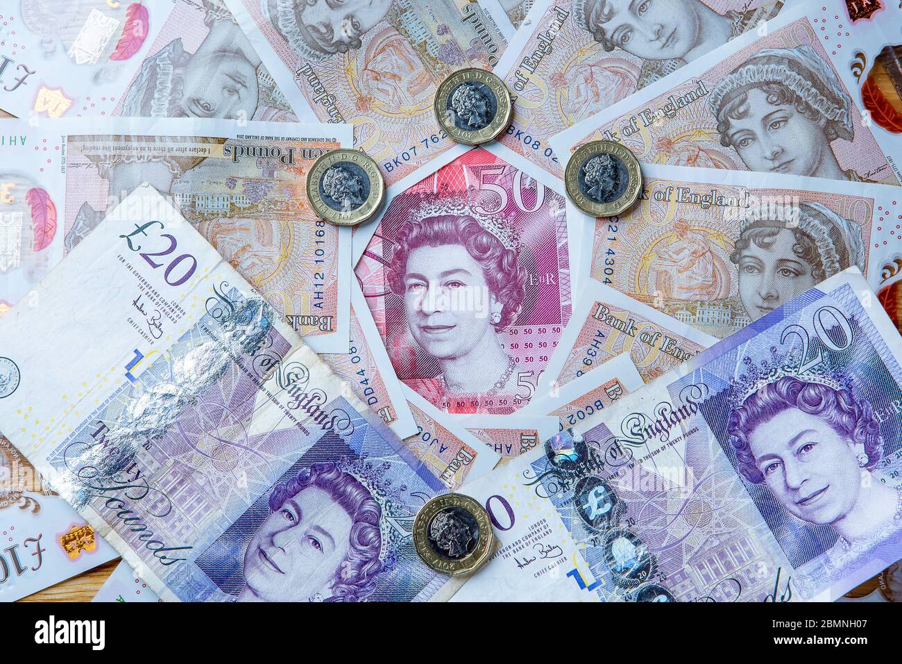 Twenty pound and fifty pound notes with one pound coins hi-res stock ...