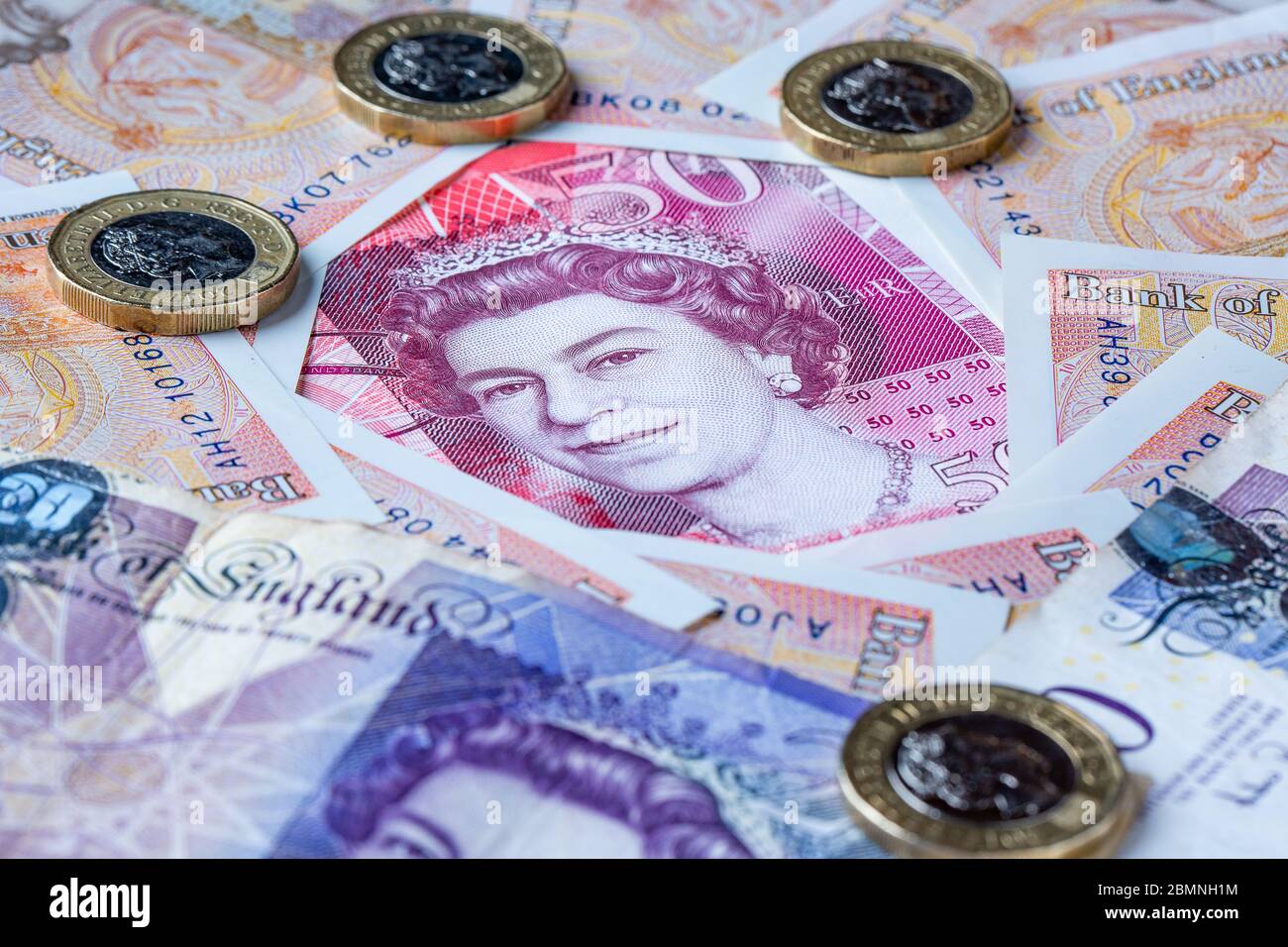 Fifty Pound note surrounded by Ten and Twenty Pound Notes with some one ...