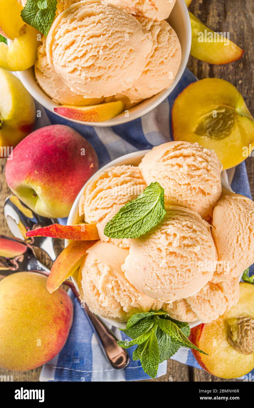 Homemade sweet peach ice cream. Peach gelato balls in small bowls, on ...