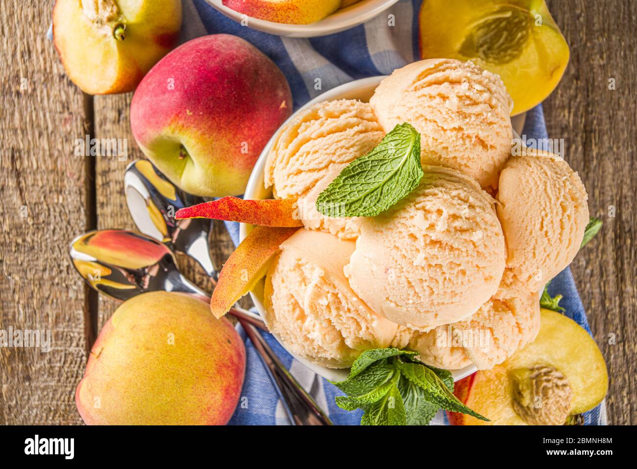 Homemade sweet peach ice cream. Peach gelato balls in small bowls, on ...