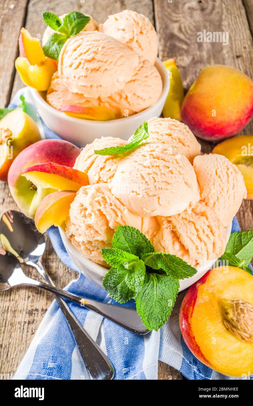 Homemade sweet peach ice cream. Peach gelato balls in small bowls, on ...