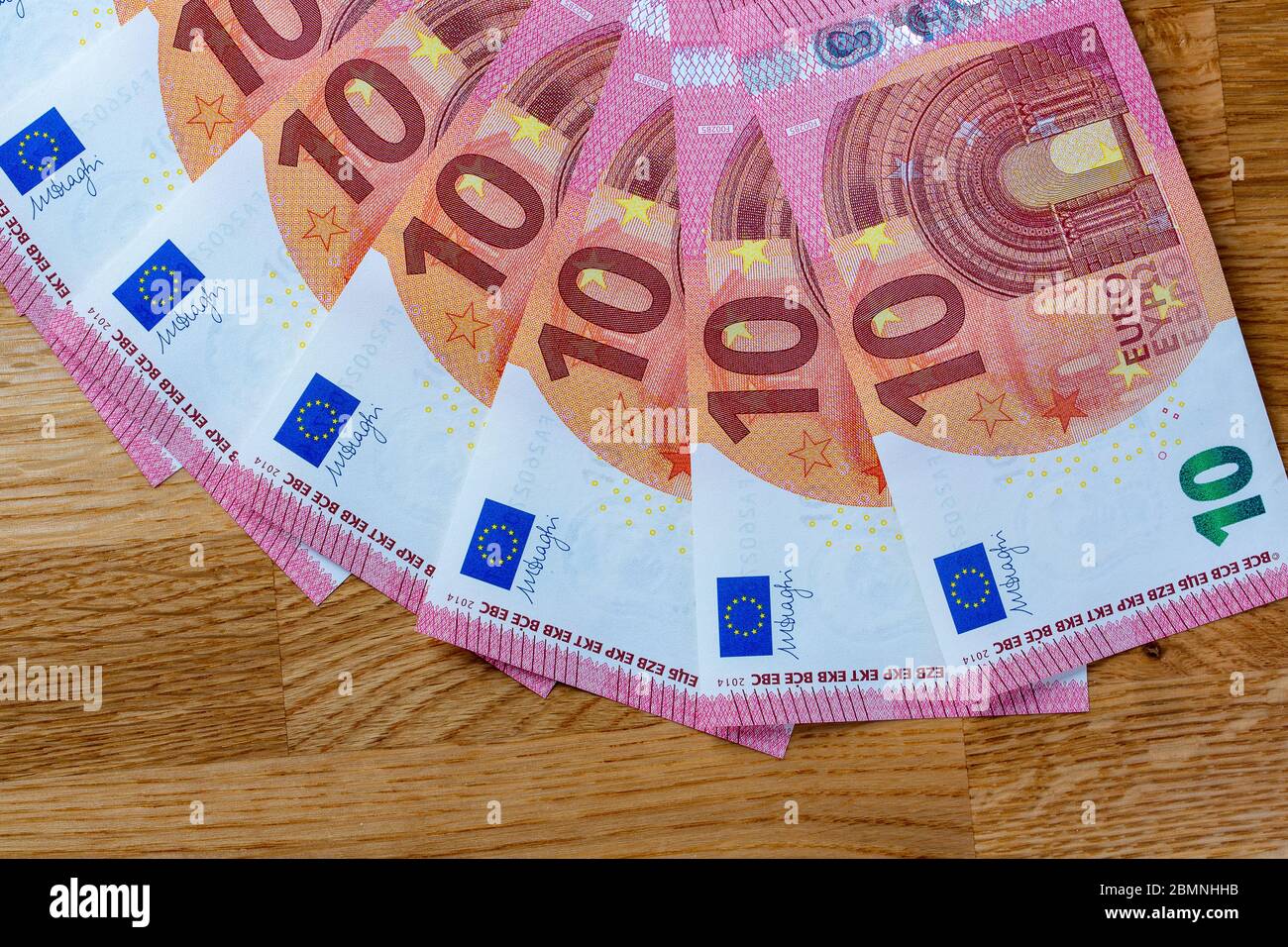 A stack of ten Euro notes laying flat, European cash currency Stock ...