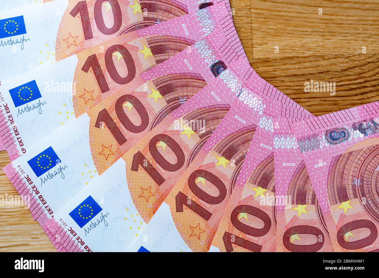 A stack of ten Euro notes laying flat, European cash currency Stock ...