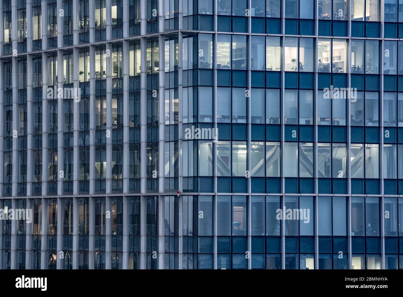 Working late. Office windows by night Stock Photo - Alamy