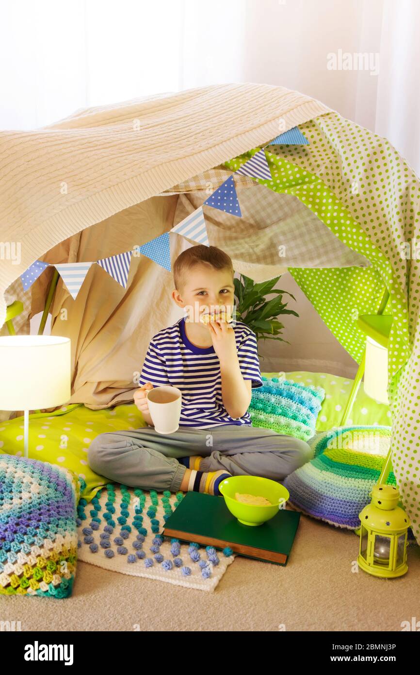 Cute boy, playing on tablet and telephone in campside, in the tent Stock Photo - Alamy