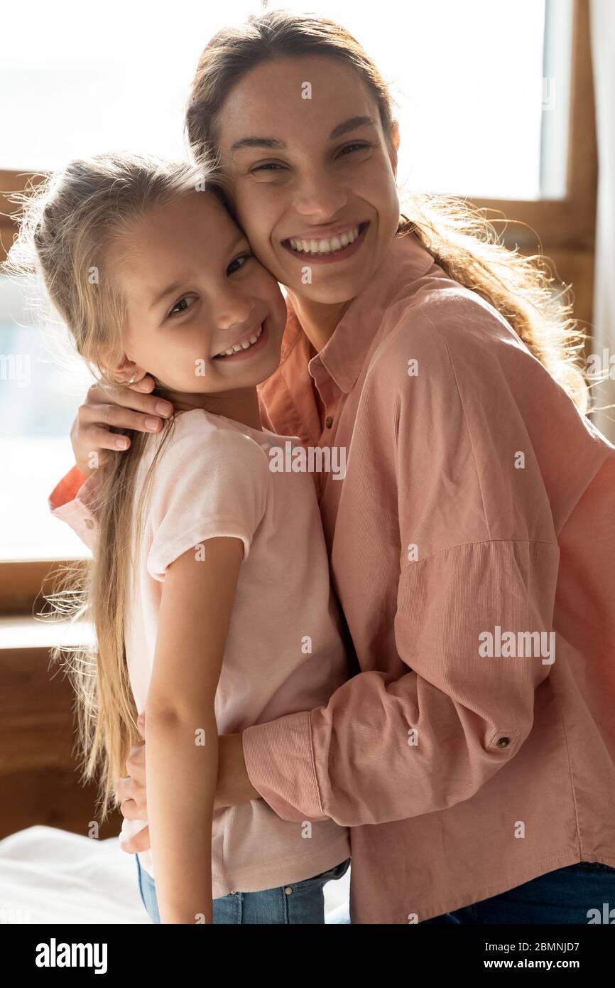 Head shot portrait happy smiling mother and adorable little daughter ... Head shot portrait happy smiling mother and adorable little daughter ...