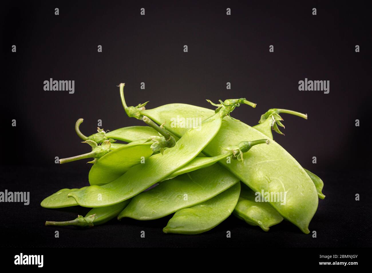 Bunch of pea pods fruit vegetable. Studio low key food still life Stock ...