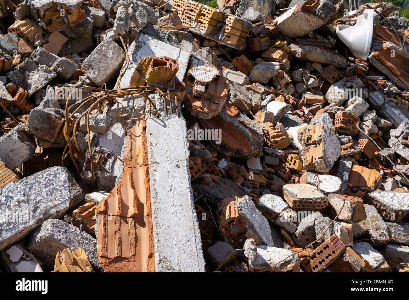 large piles of rubble and broken bricks and cinder blocks from ...
