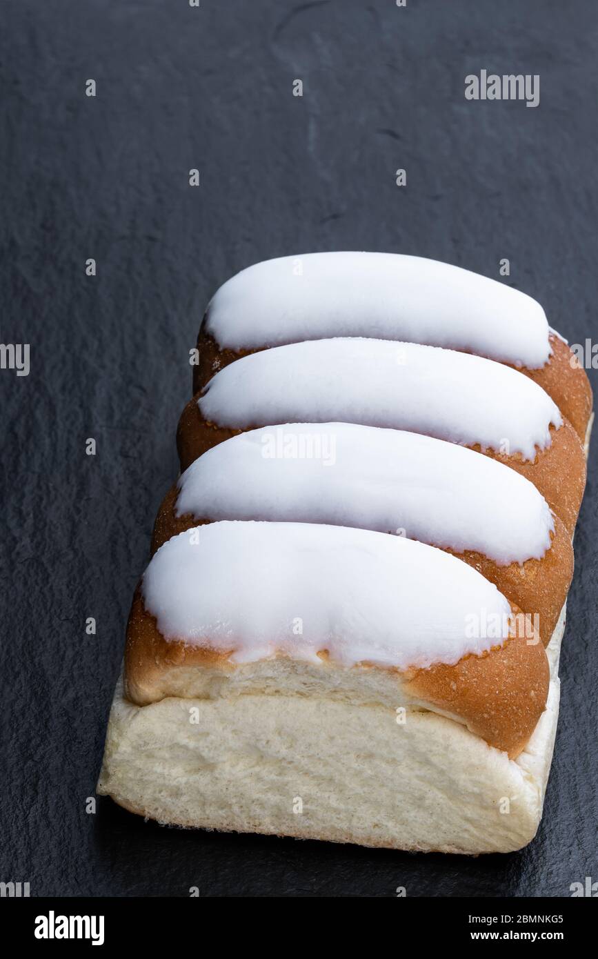 Iced finger buns on black stone background Stock Photo - Alamy