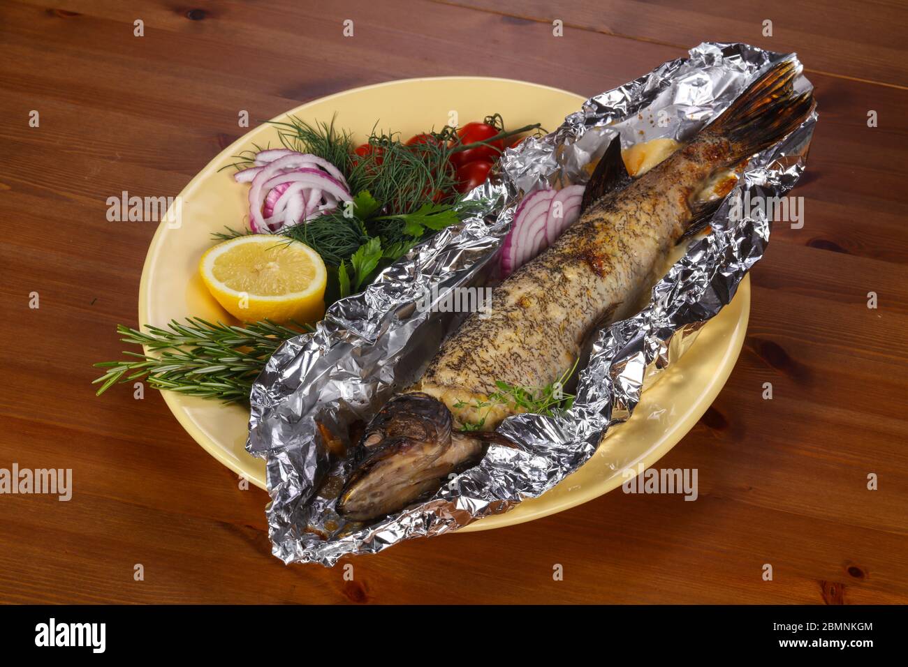 Stuffed baked pike with lemon and rosemary Stock Photo - Alamy