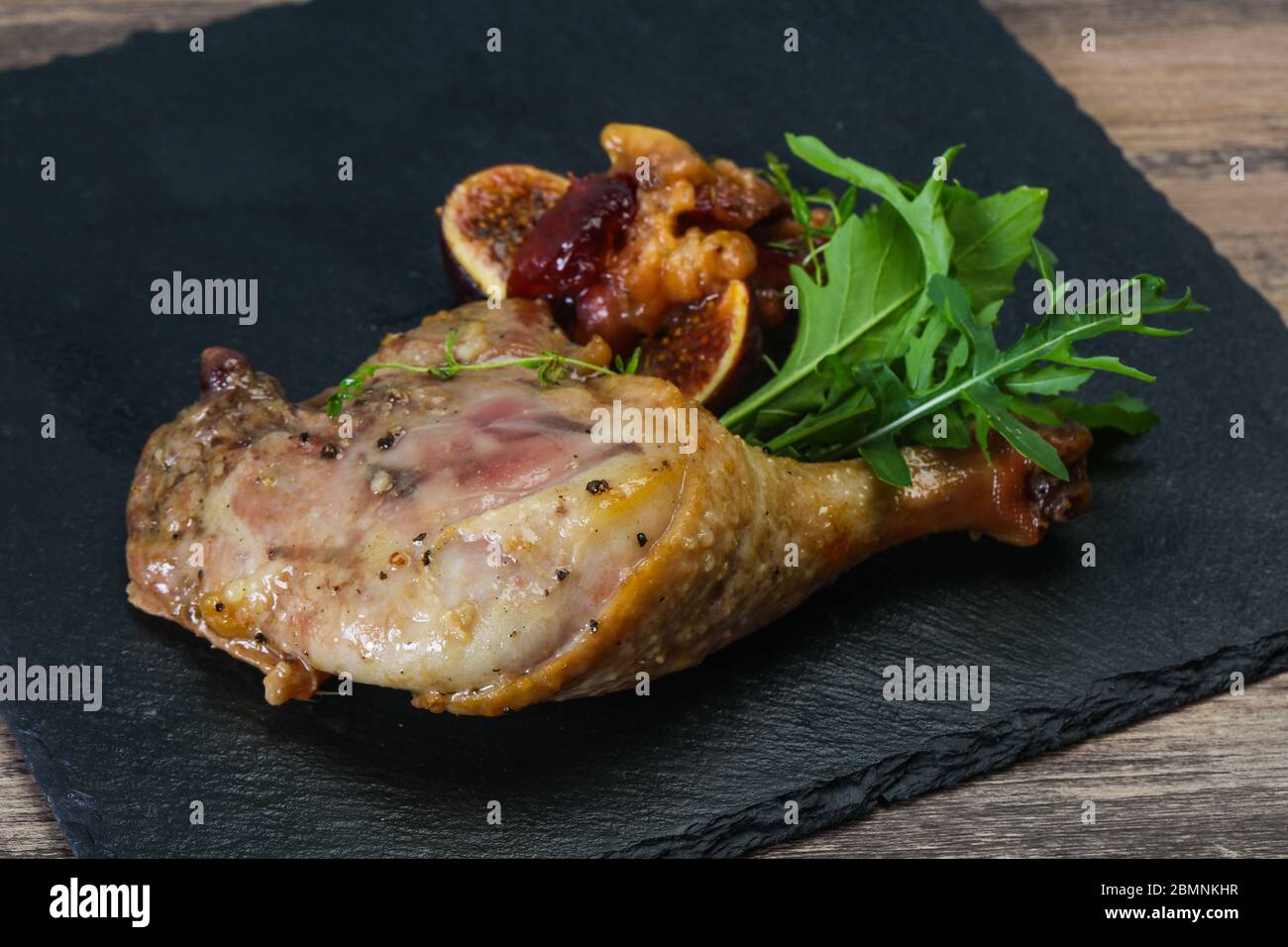 Roasted. duck. leg with plum, fig and apple Stock Photo - Alamy