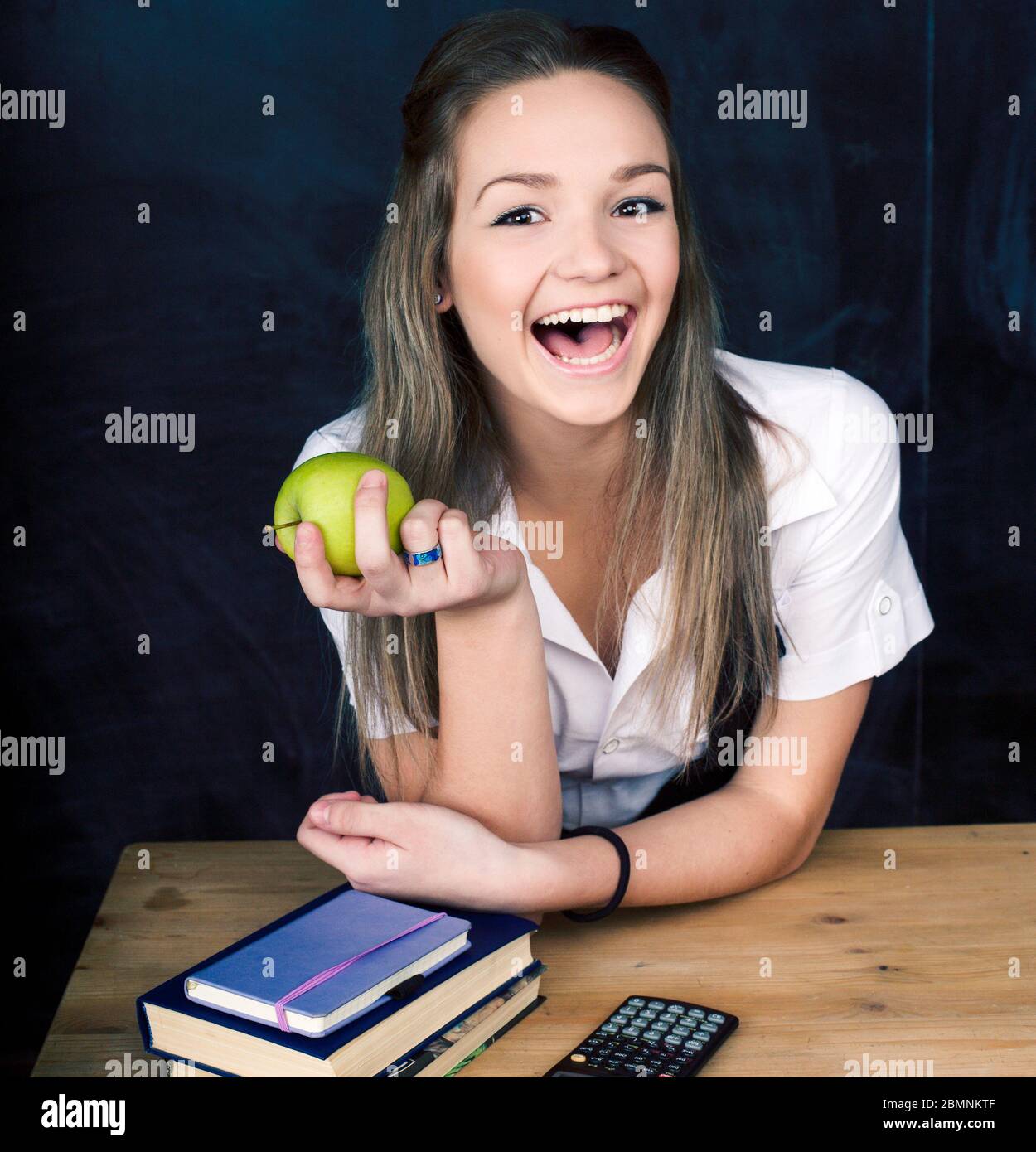 portrait of happy cute student with book in classroom Stock Photo - Alamy