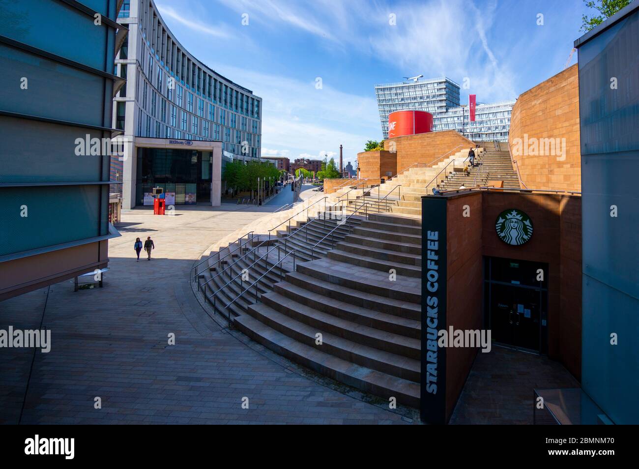 A couple walking below the outdoor steps of Liverpool ONE during the ...