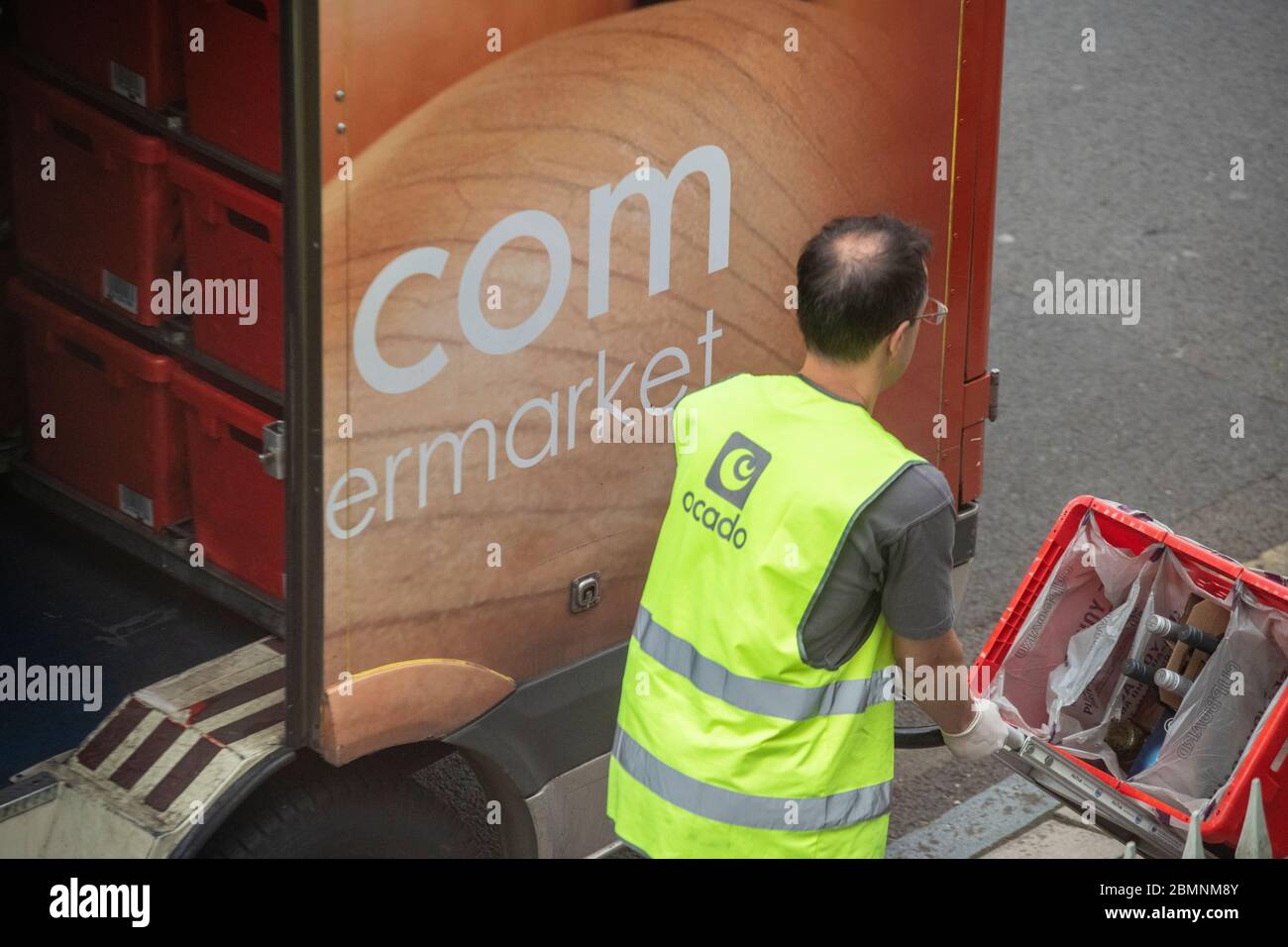 An Ocado employee unpacks supermarket shopping for a home delivery ...