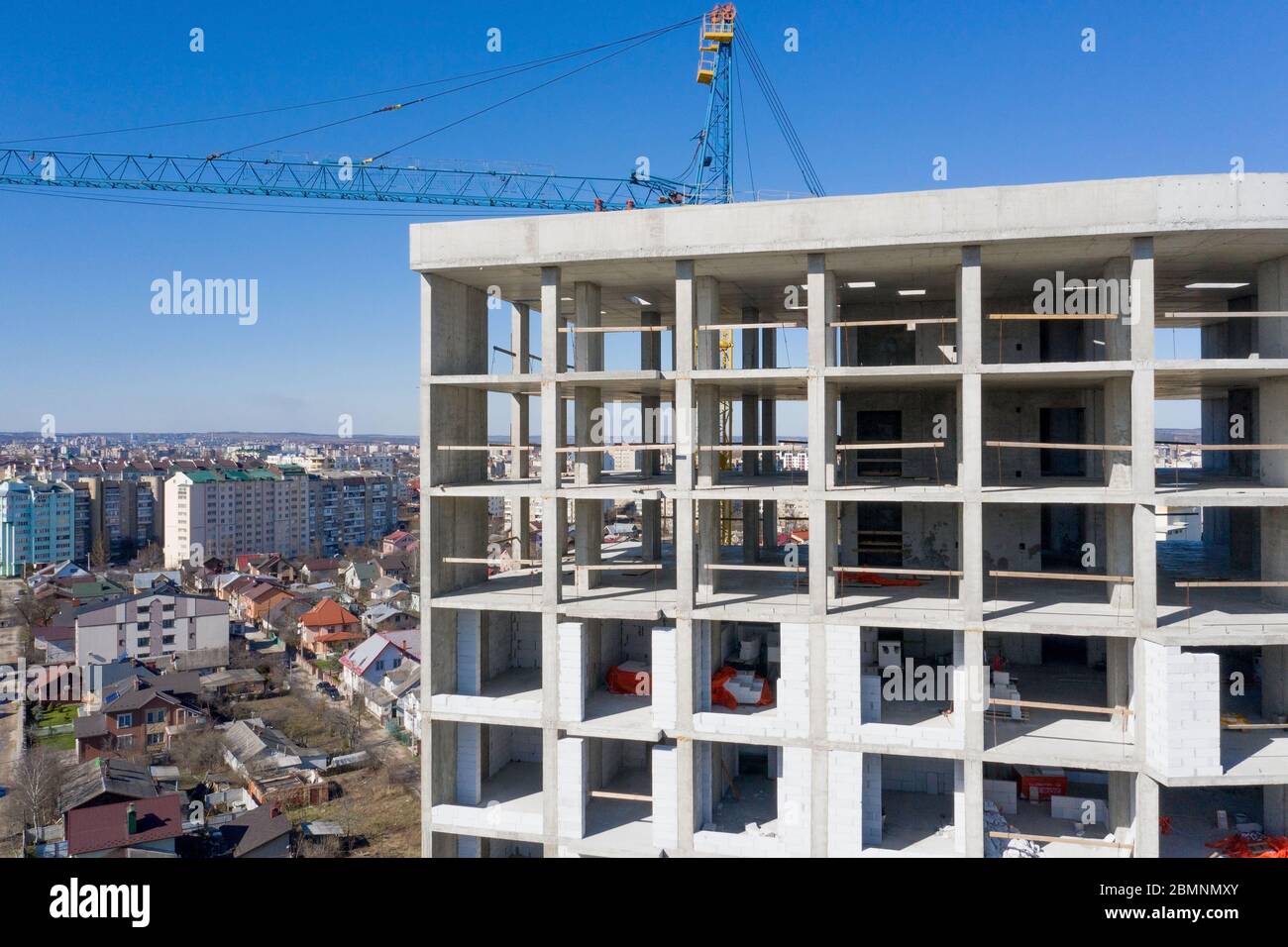 Aerial view of concrete frame of tall apartment building under ...