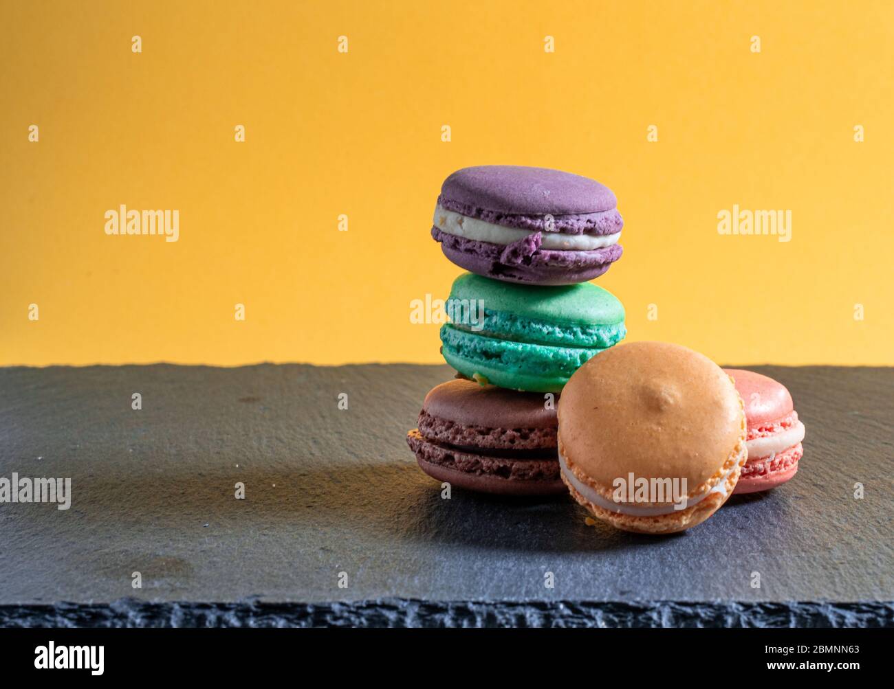 Group of five macaroons of different colours arranged on top of each ...