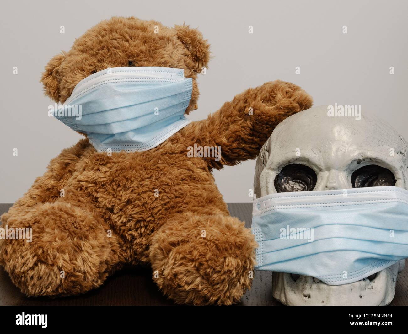 Teddy bear and skull both wearing a covid 19 coronavirus mask Stock ...