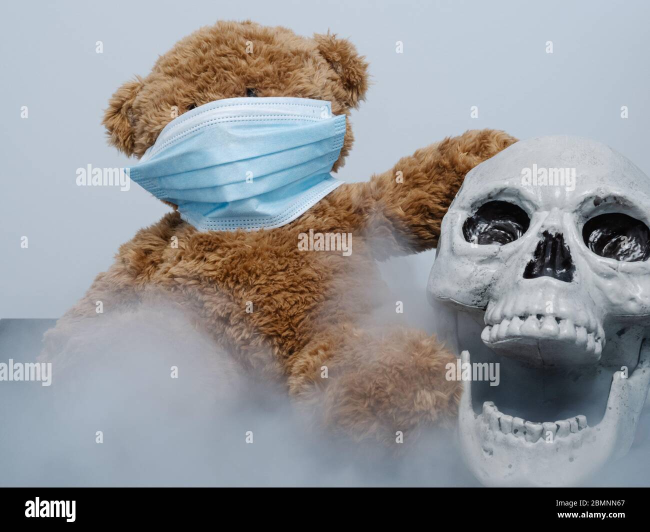 Teddy bear and open-mouthed skull with covid 19 coronavirus mask ...