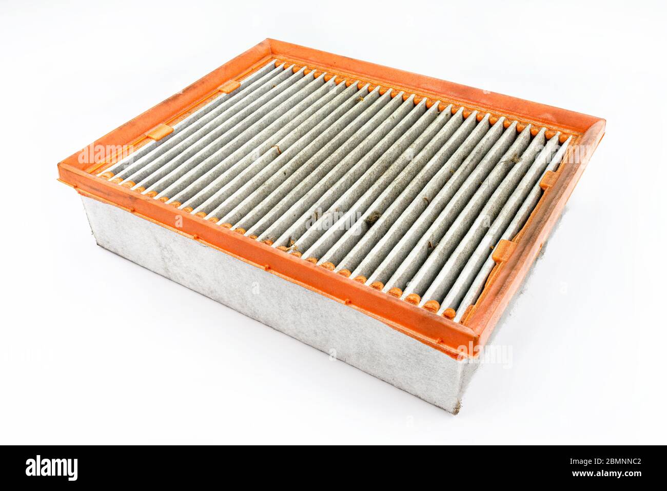 Worn and dirty rectangular car air filter, visible leaves and dirt ...