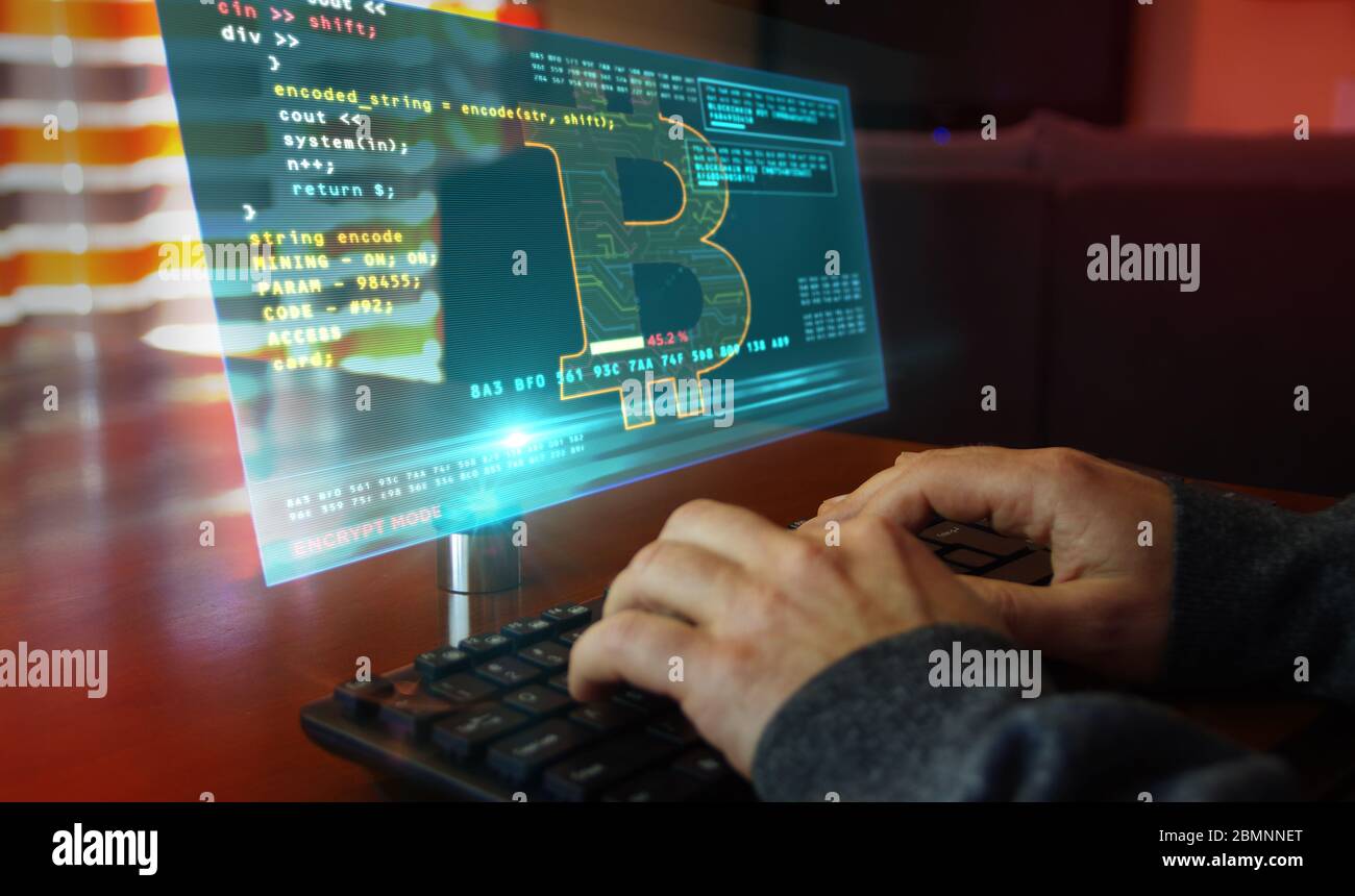 Hacker typing on the keyboard and Bitcoin mining on hologram screen on ...