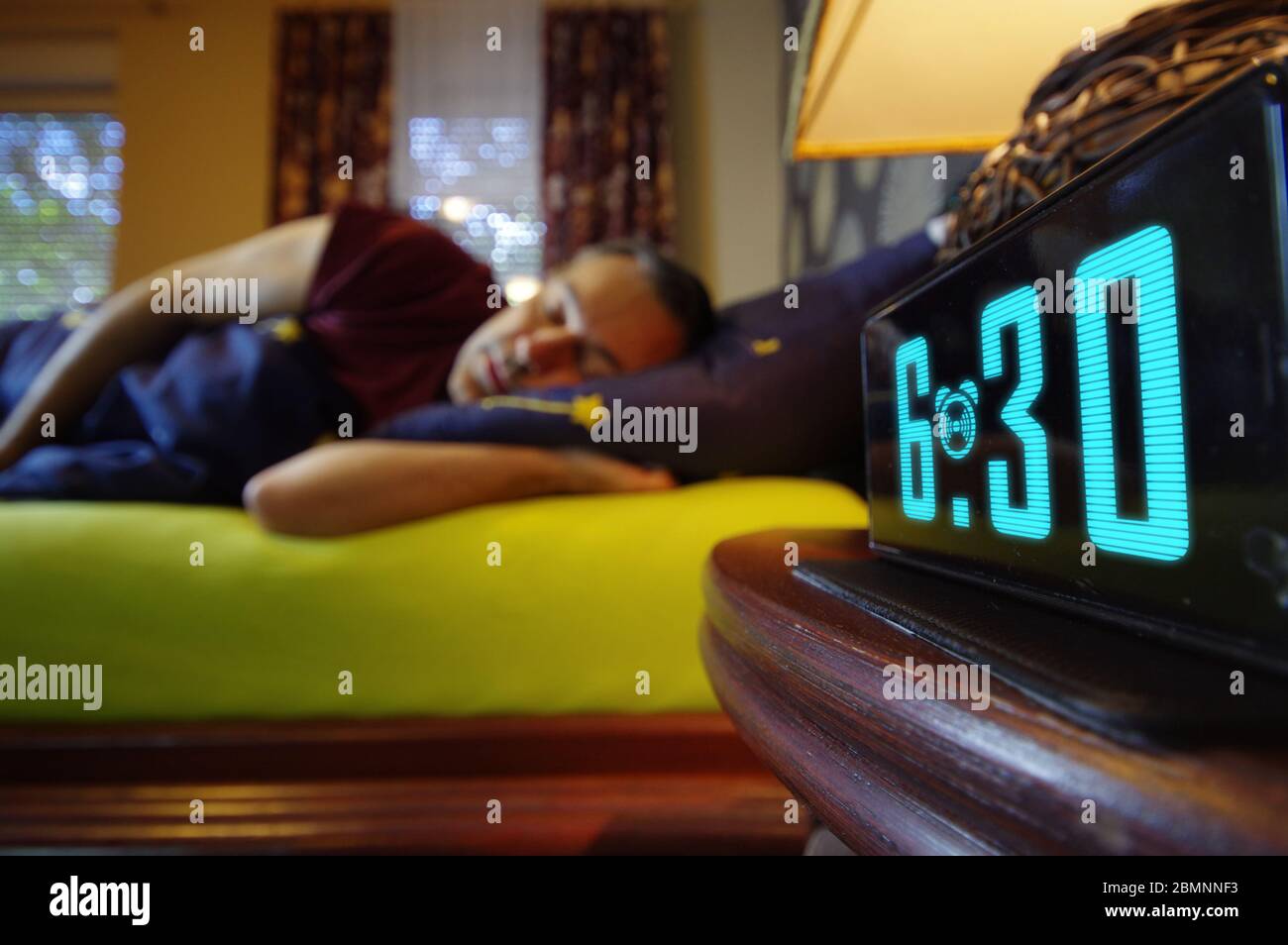 Morning wake up in the bedroom. The man sleep. Early clock time at the ...