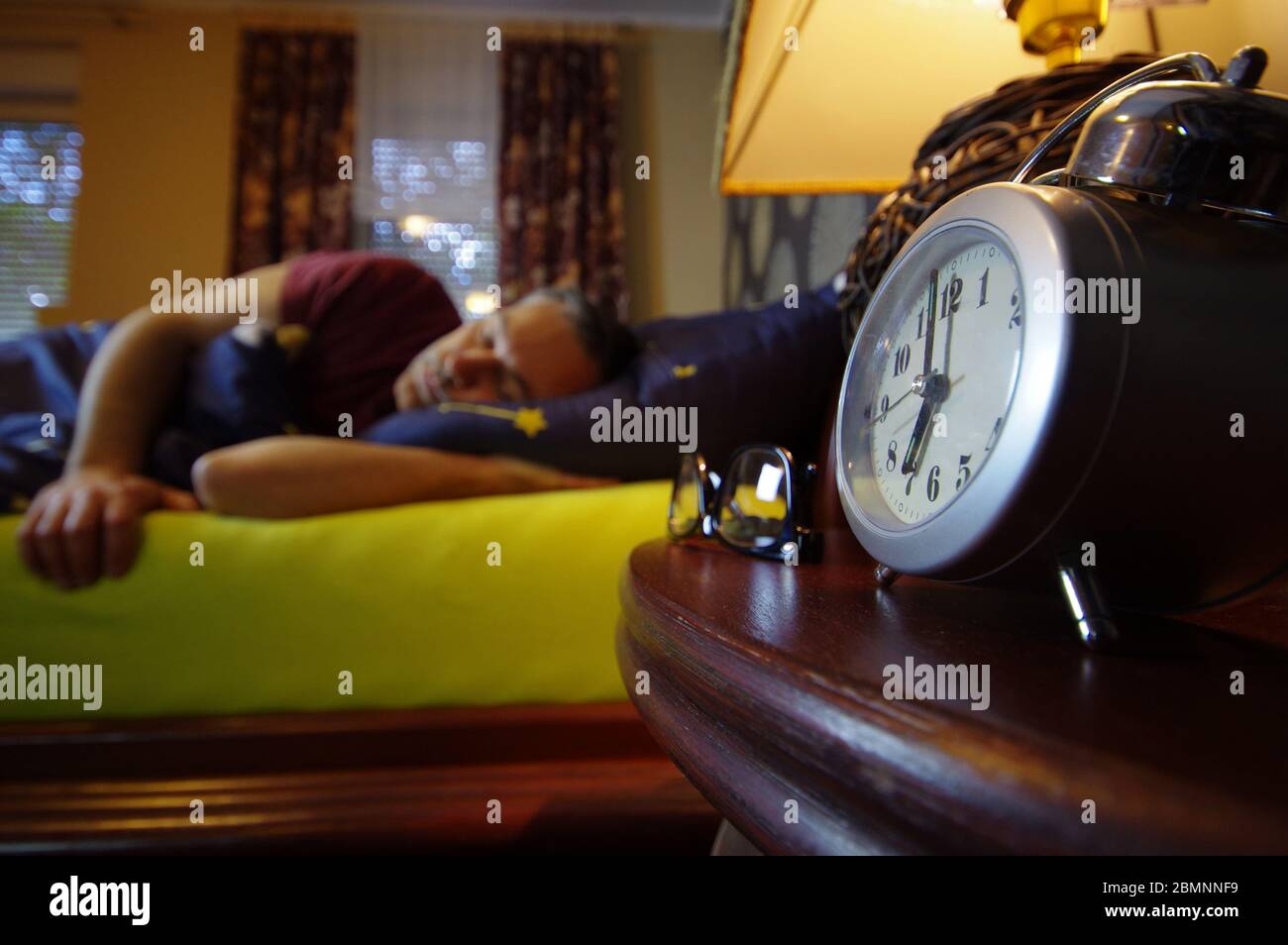 Morning wake up in the bedroom. The man sleep. Early clock time at the ...