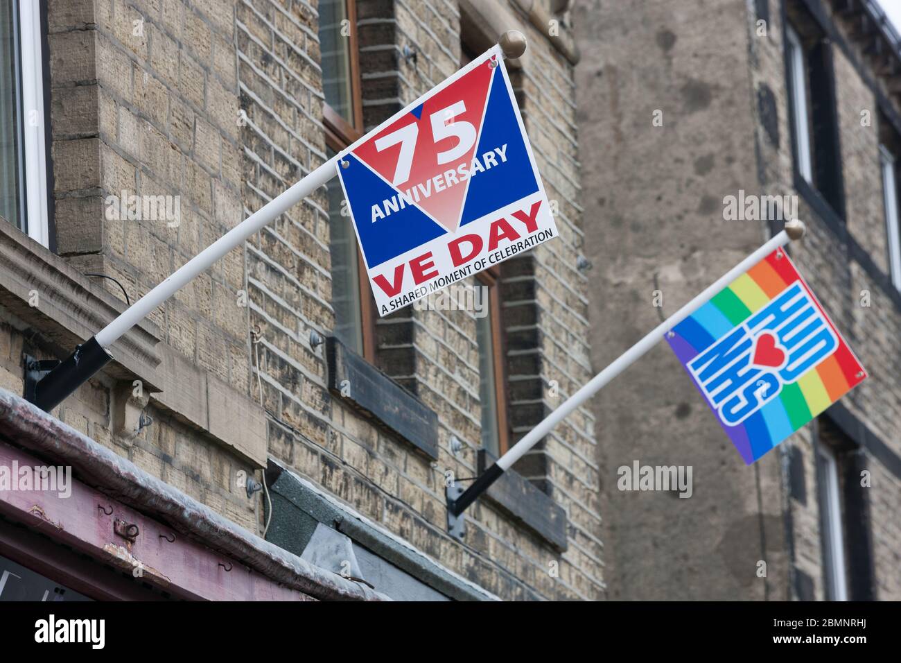 Meltham, UK - May 5 2020: A VE day anniversary flag next to an NHS ...