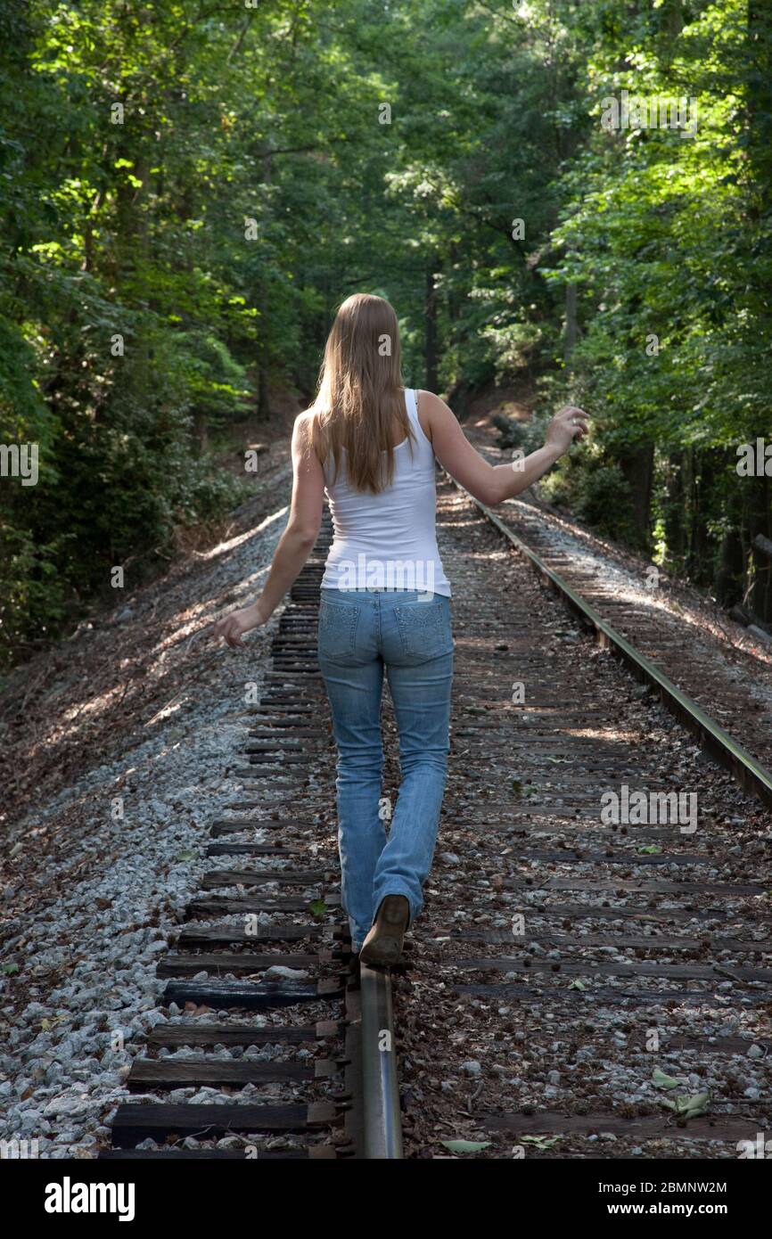 Pretty Blond woman on railroad tracks Stock Photo - Alamy