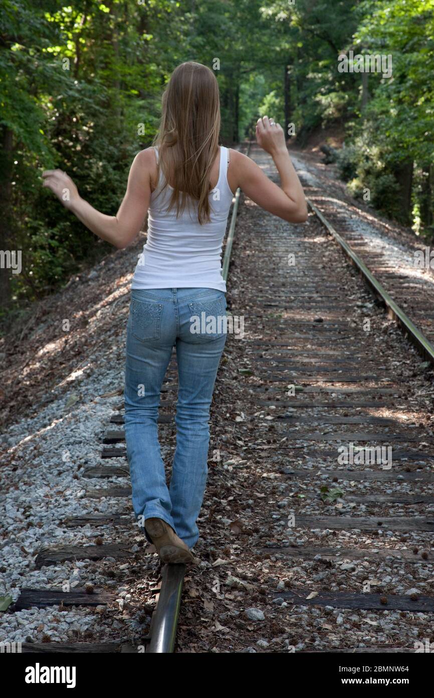 Pretty Blond woman on railroad tracks Stock Photo - Alamy