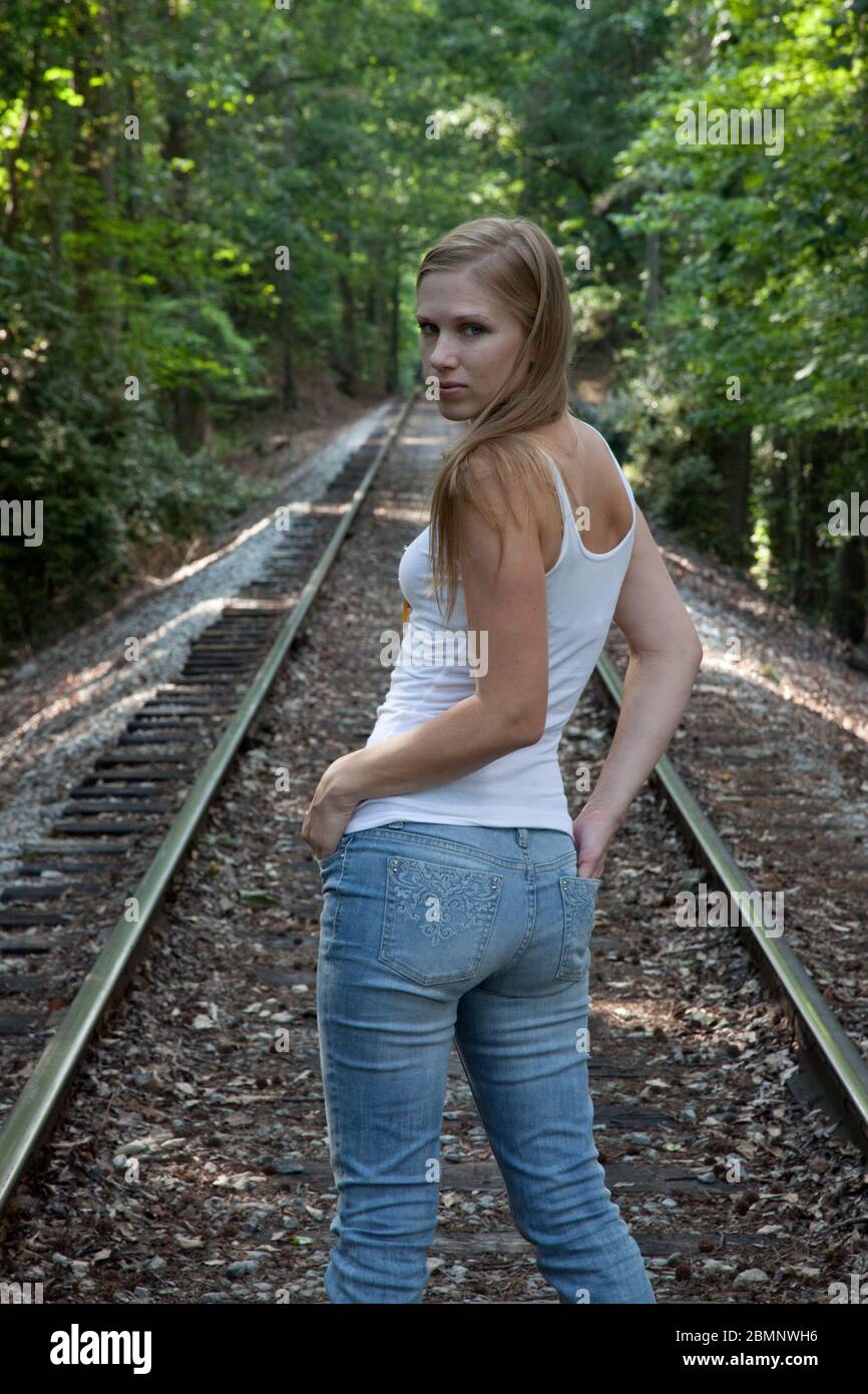 Pretty Blond woman on railroad tracks Stock Photo - Alamy