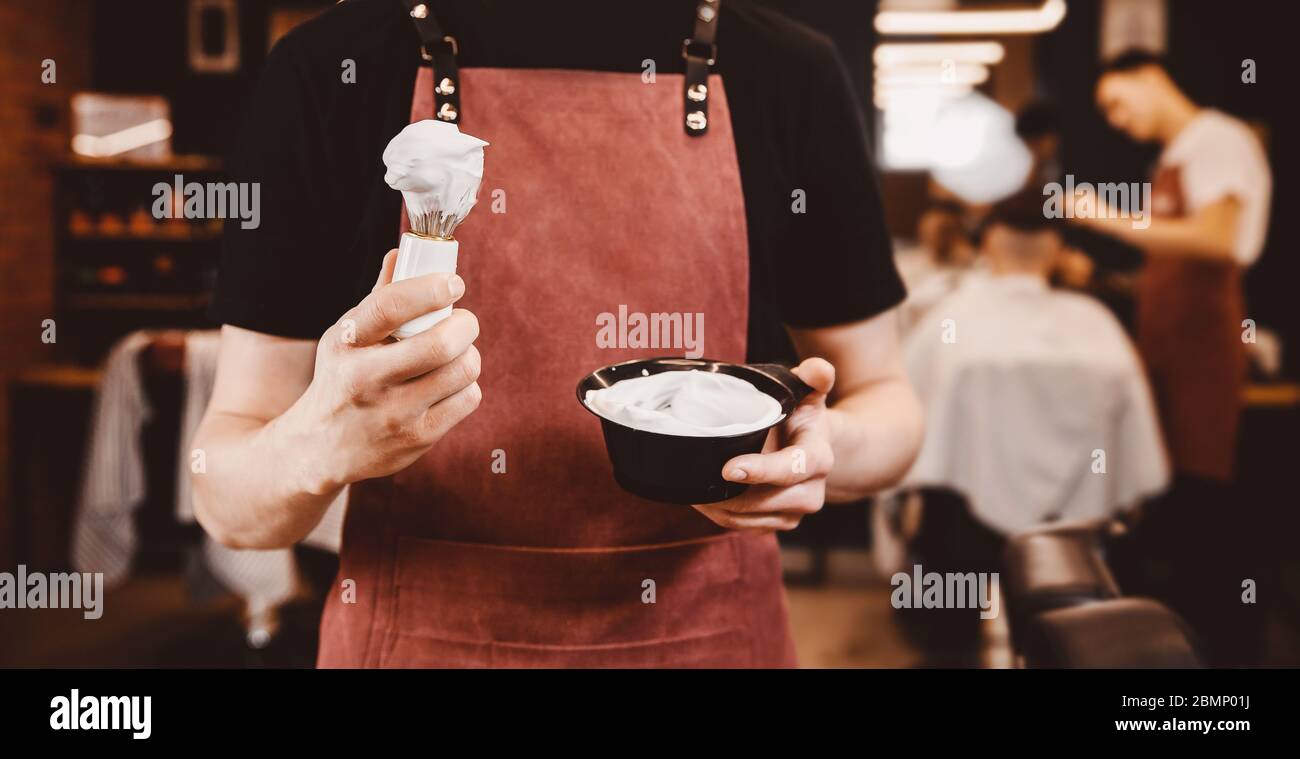 Shaving with steel blade of beard and mustache in barbershop, barber ...