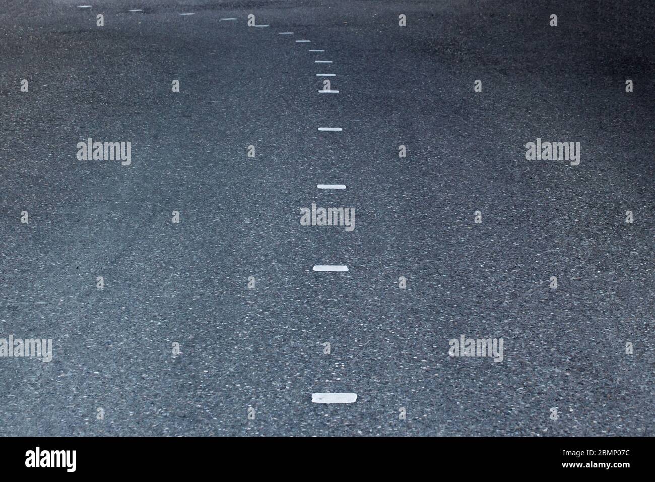 White square road markings making a curve in the distance Stock Photo ...