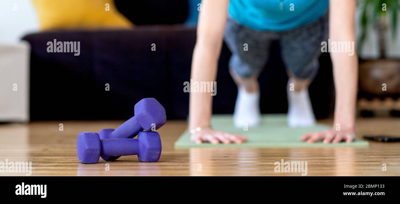 woman doing exercise at home stay fit indoors focus on dumbells Stock ...