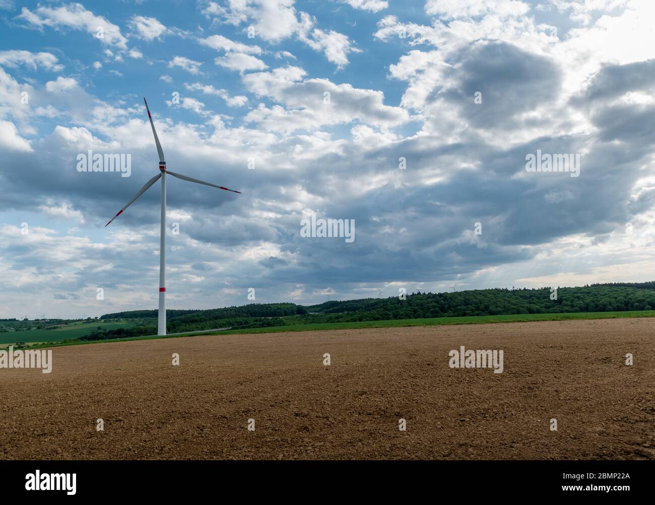 different windmills and wind wheel at a field in Germany Stock Photo ...