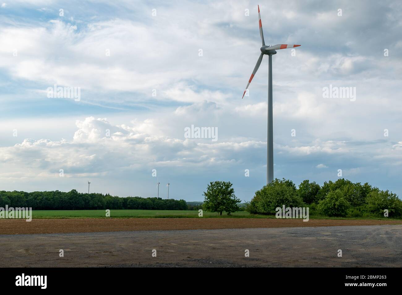 different windmills and wind wheel at a field in Germany Stock Photo ...