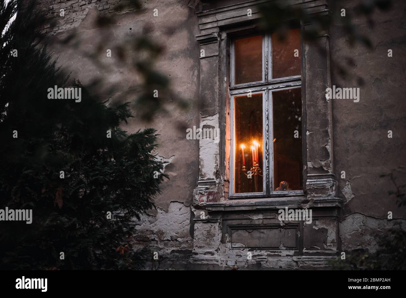 photo of an old house window with candles inside Stock Photo - Alamy