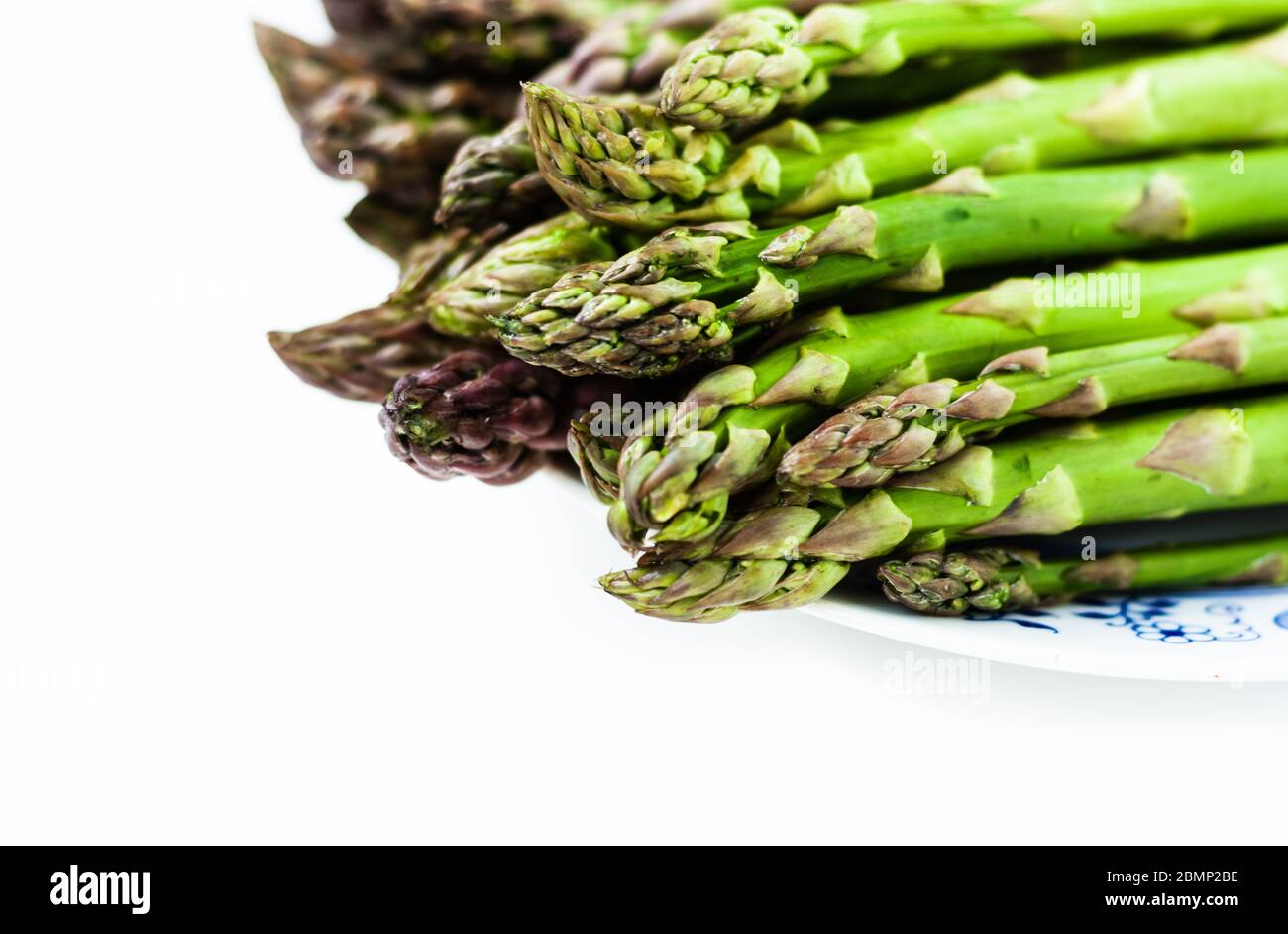 Bunch of fresh raw asparagus on white background, vegetarian concept ...