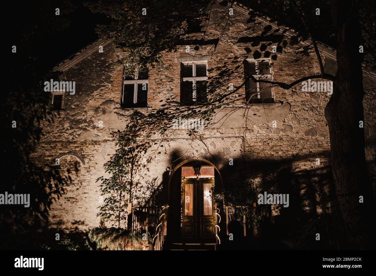 photo of an old house in the nature at night Stock Photo - Alamy