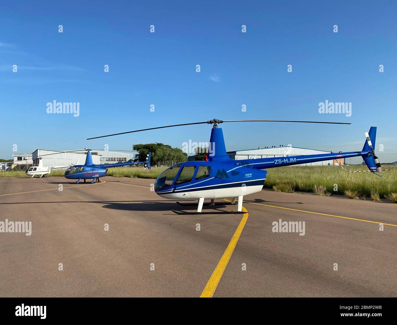 These helicopters are parked at the local airport and must be refuelled ...