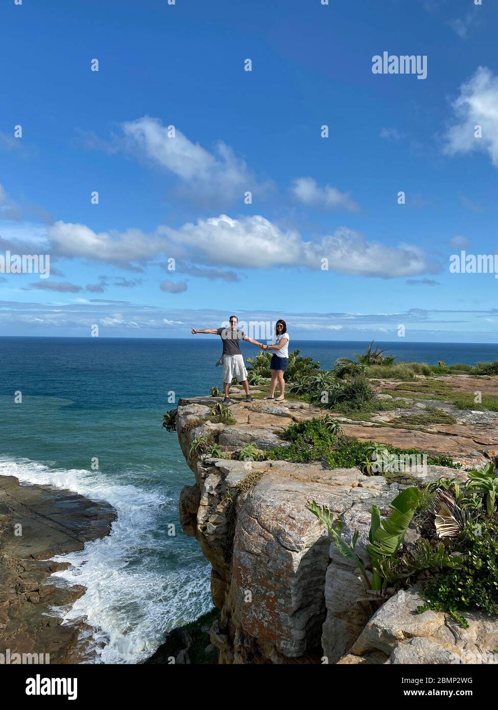 These two young people have passed an overhanging cliff, with the woman ...