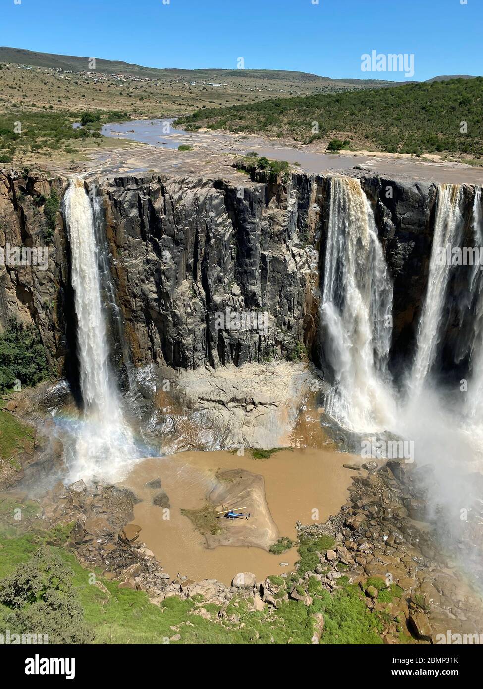 An experienced pilot has parked his helicopter below the big waterfall ...