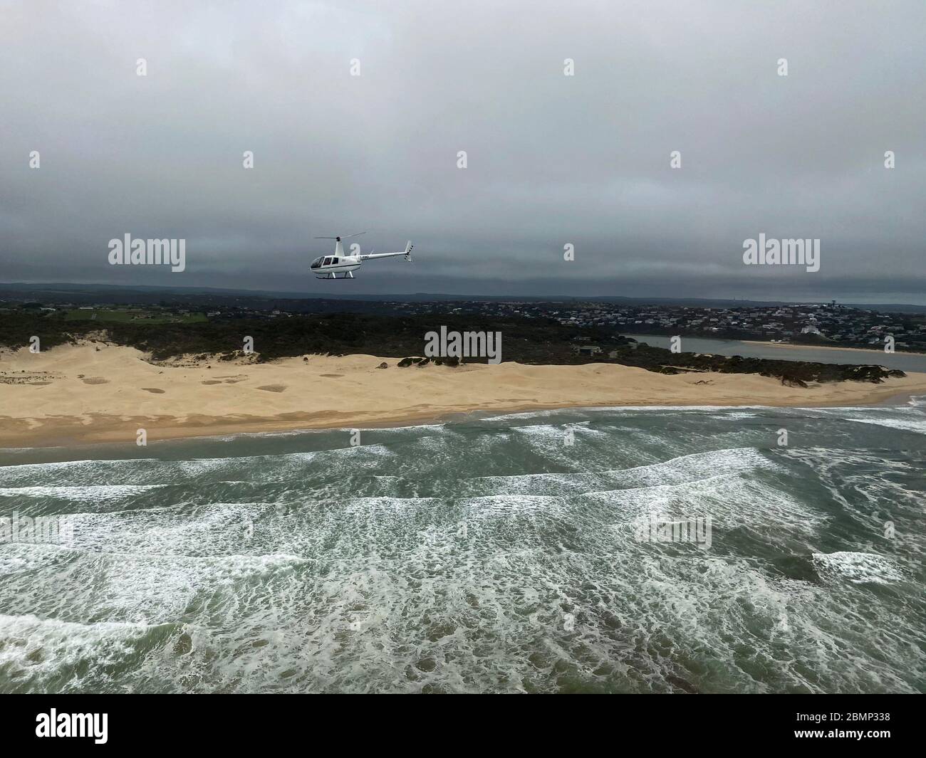 The bad weather does not prevent the helicopter pilot from flying his ...