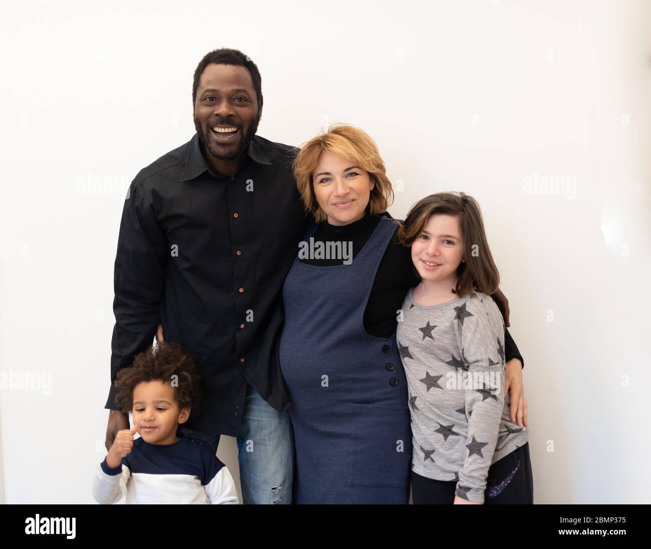 portrait of a multi-racial family on a white background, African father ...