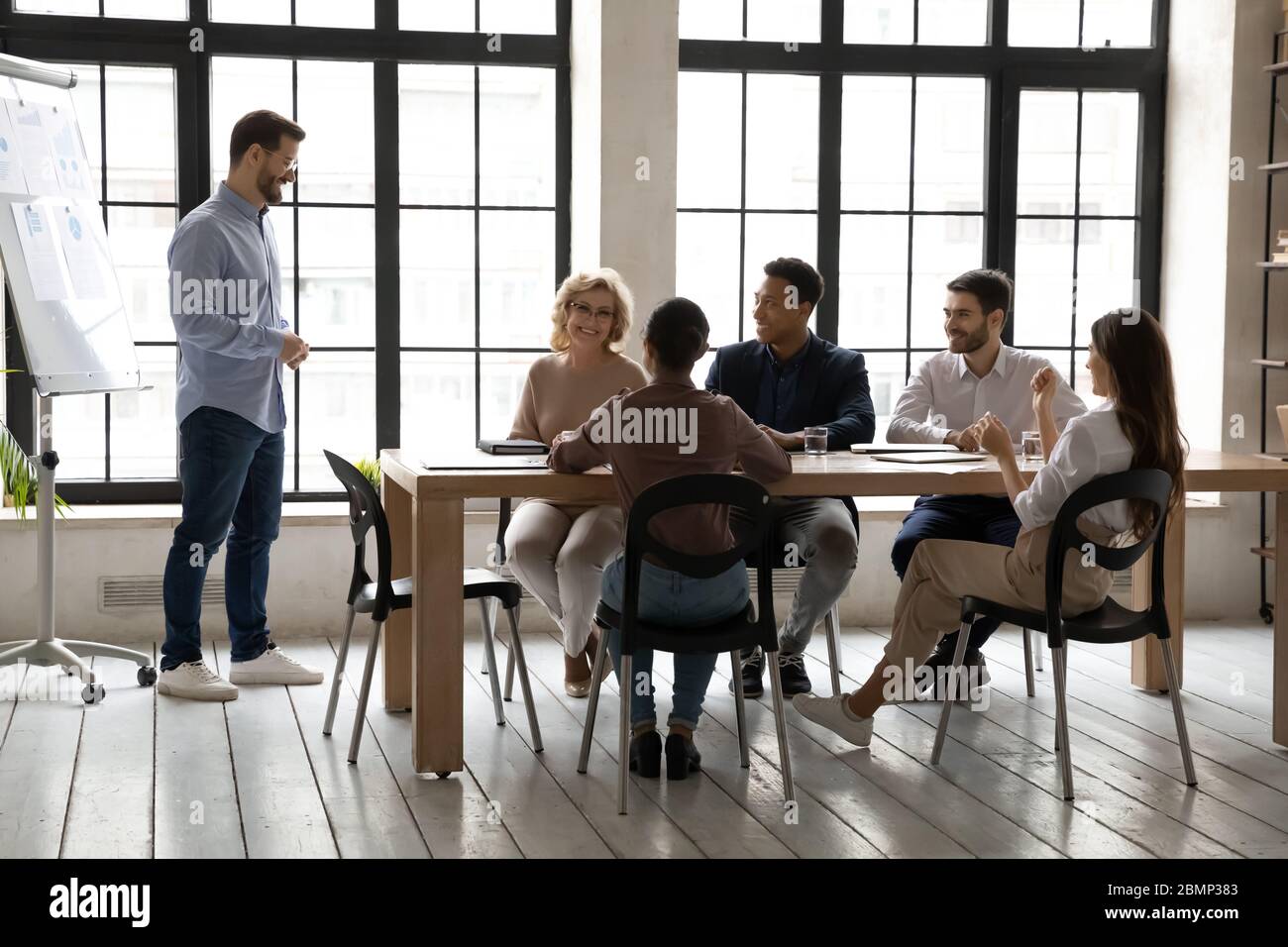 Smiling businessman waiting for decision from diverse colleagues on ...