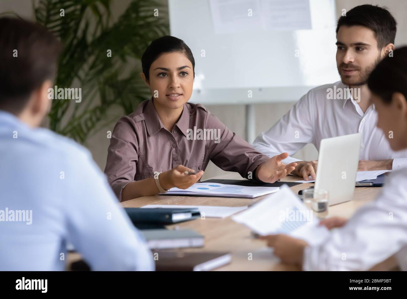 Attractive indian ethnic businesswoman with businessman partner talking ...