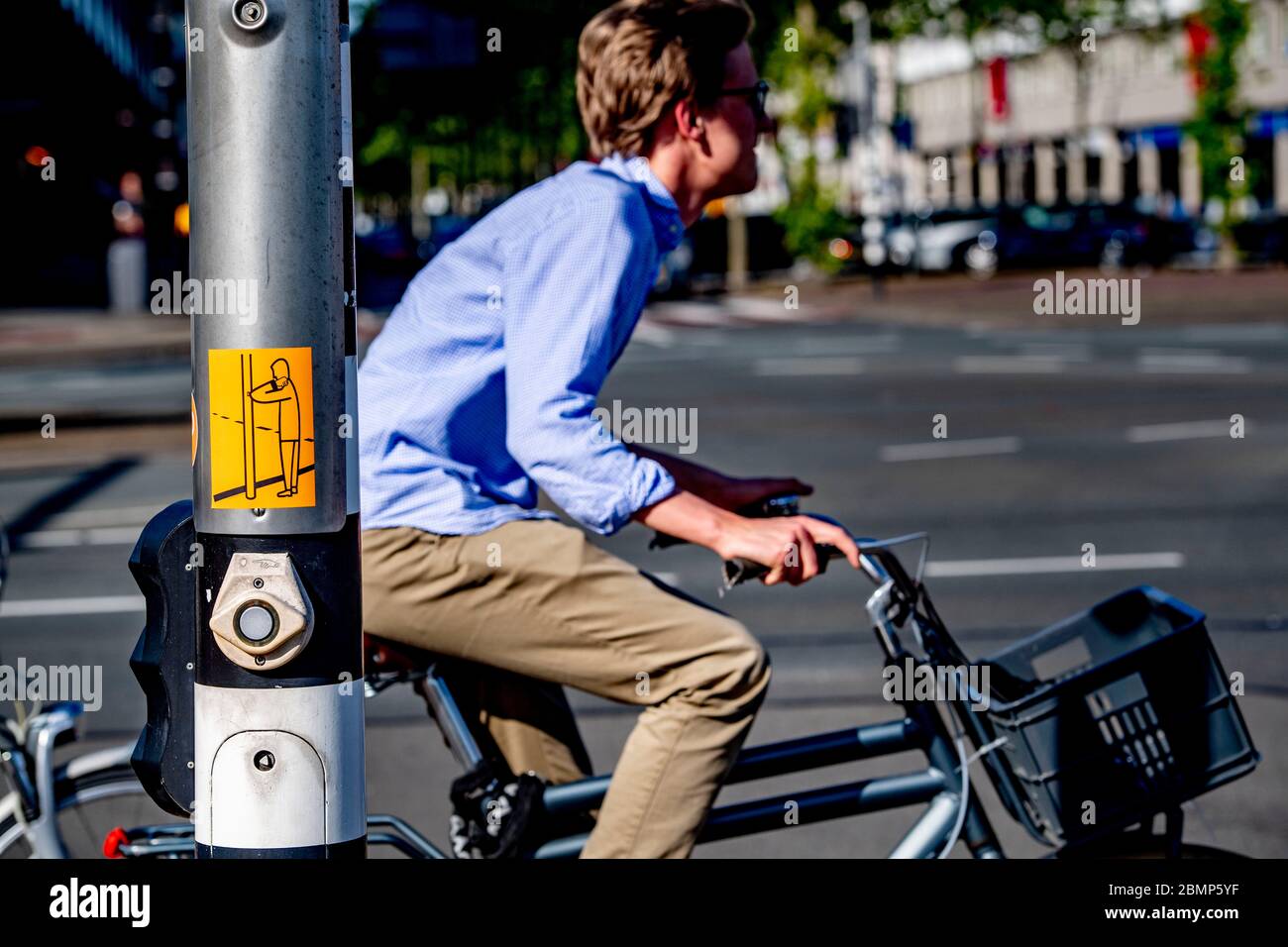 A view of an elbow use sticker at the traffic lights during the ...